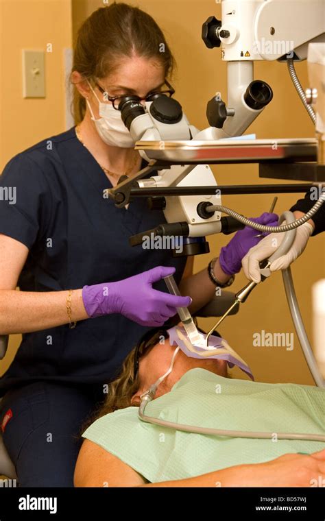 A Female Woman Patient Receives A Root Canal From A Female Woman