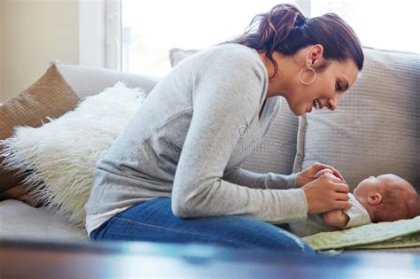 Bonding Time A Mother Sitting With Her Newborn Baby On A Couch Stock Image Image Of Home