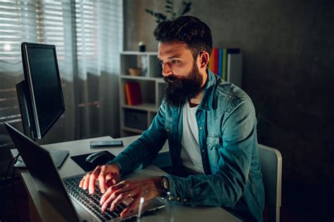 An Intelligent Data And Computer Scientist Is Typing On A Laptop And Working Remotely From His