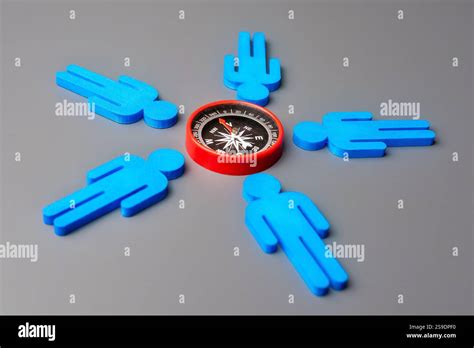 A Compass Surrounded By Blue Figures Symbolizing Leadership Guidance