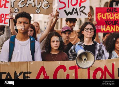 Youth Activists Holding Up Banners And Placards During An Anti War