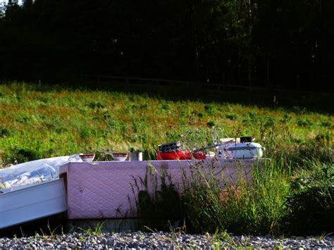 household garbage illegally dumped in countryside field stock image