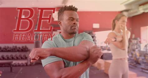 Image Of Be Healthy Text Over Diverse Man And Woman Exercising In Gym