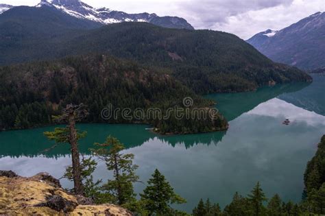 A Stunning Cloudy Morning View Of A Glacial Blue Lake In North Cascades