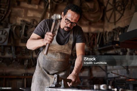 대장장이 제조 작업장 공장 제품 엔지니어링 또는 금속 생산에서 사람 망치 및 철 모루 산업 디자인 강철 위조에 있는 노동자 육체 노동 및 주조 산업 장비 45 49세에 대한