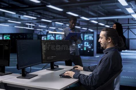 multiracial team in data center facility running system diagnostic