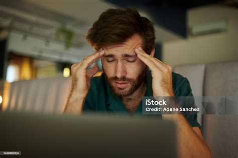 스트레스 우울증 및 피곤한 남자는 밤에 두통 소진 및 초과 근무로 집중하기 위해 고군분투하는 노트북에서 원격 작업을합니다 프리랜서 남성의 얼굴은 러시아에서 스트레스와 과로를