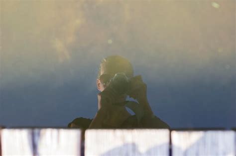 Premium Photo High Angle View Of Man Reflection In Lake While Using Camera