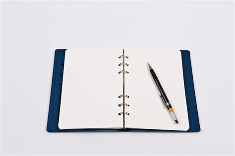 Premium Photo A Blue Notebook With A Pen On It And A Pen On The Top