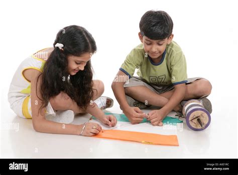Babe And A Girl Tying String To A Kite Stock Photo Alamy