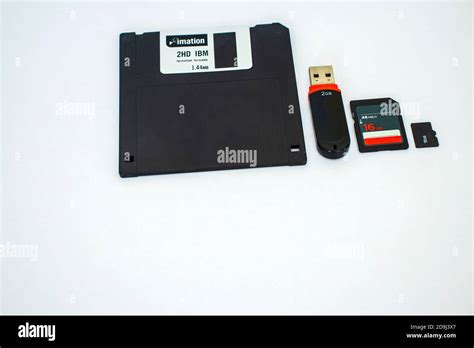 old floppy disk usb flash memory card and micro memory card on white background indoors stock