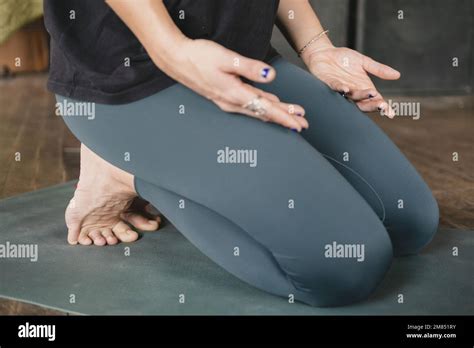 Unrecognizable Woman Yogi Meditating In Kneeling Pose With Tucked Toes Hands Resting On Legs