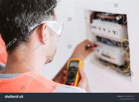 Electrician Measuring Voltage Near Fuse Box Stock Photo 2431831577 Shutterstock