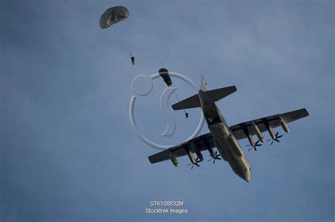 Personnel Jump From A C 130 Hercules During A Static Line Jump