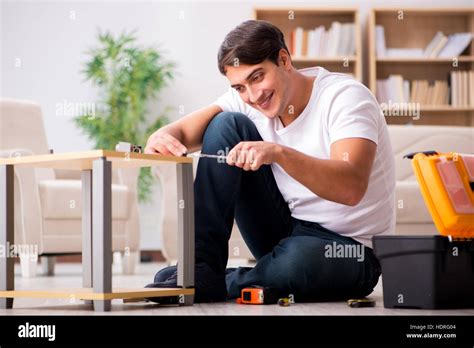 Man Assembling Shelf At Home Stock Photo Alamy