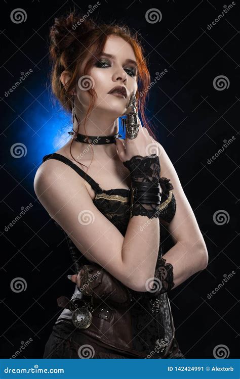 A Beautiful Thoughtful Redhead Cosplay Girl Wearing A Victorian Style Steampunk Costume With Big