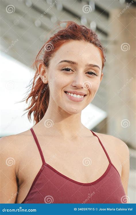 Vertical Individual Portrait Of One Redhead Female Smiling And Looking