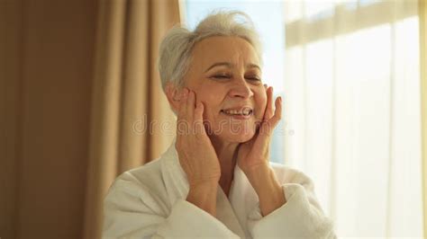 Mature Adult Old Woman Applying Nourishing Anti Age Face Cream Doing