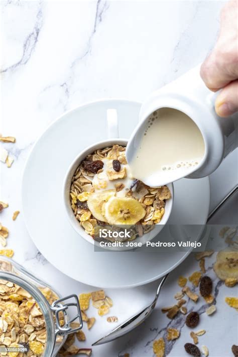 통곡물 아침 시리얼과 우유 주전자를 곁들인 우유 그릇 말린 과일과 말린 과일을 곁들인 뮤즐리 복사 공간을 가지고 있습니다 가벼운 배경에 0명에 대한 스톡 사진 및 기타