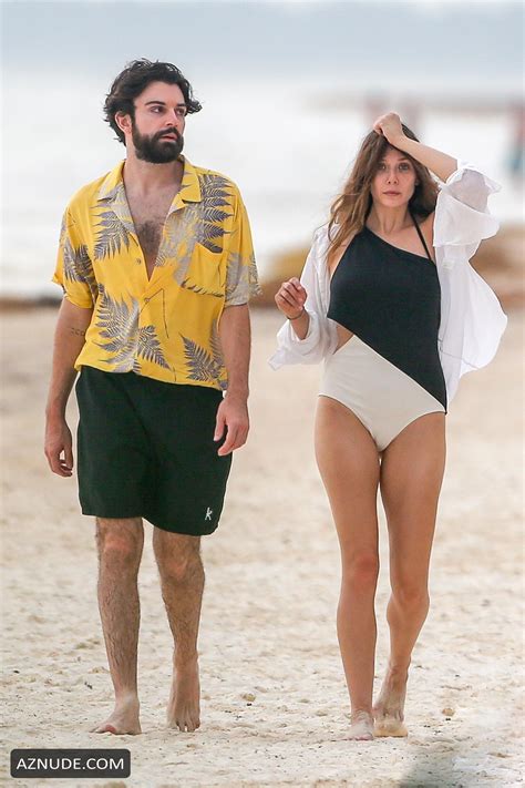 Elizabeth Olsen Sexy In A Black And White Swimsuit With Boyfriend Robbie Arnett On The Beach In