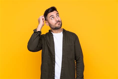 Premium Photo Man Isolated Having Doubts And With Confuse Face Expression