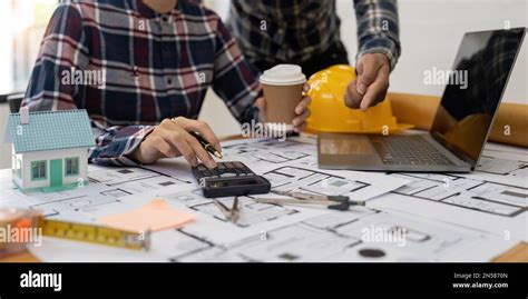 Close Up Architect Or Engineer Using On Calculator For Calculating Value Estimating For Safety