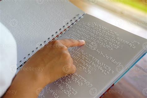 Visually Impaired Person Reads With His Fingers A Book Written In Braille It Is Written For