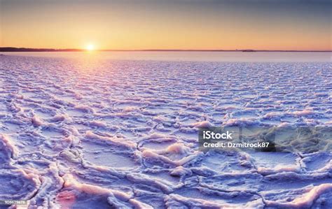 얼음 호수 석양 텍스처 균열 및 얼음에 패턴에 북극 찬 풍경 서리가 이날 석양의 겨울 풍경입니다 얼어붙은 호수의 지평선에 태양입니다 0명에 대한 스톡 사진 및 기타 이미지