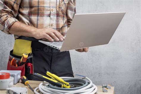 Electrician Checking Repair Maintenance Electric System And Using Laptop Computer Stock Image