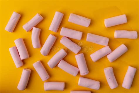 Assorted Marshmallows Randomly Placed On A Yellow Background From A Top