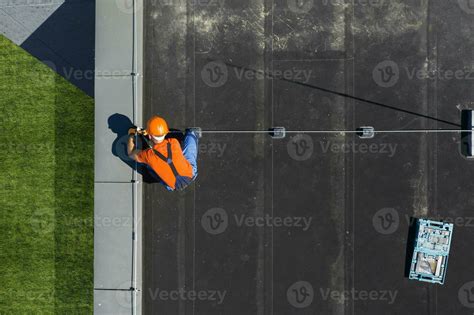 Technician Installing Lightning Protection Rod On Top Of Building
