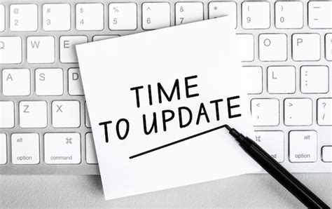 Premium Photo White Paper With Text Update Lying On The Keyboard