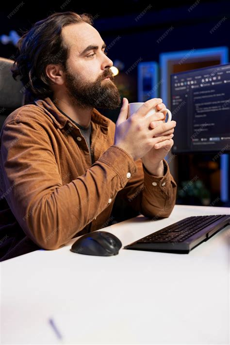 Premium Photo Programmer Drinking Coffee And Writing Lines Of Code