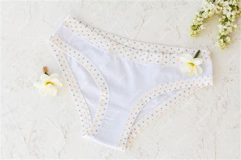 Premium Photo White Cotton Panties With Buds Of Daffodil Flowers On