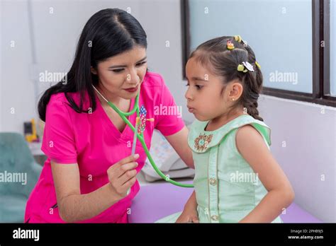 Pediatrician Checking A Girls Lungs Having Her Blow Into A Pinwheel