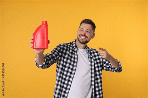 Man Pointing At Red Container Of Motor Oil On Orange Background Stock Photo Adobe Stock
