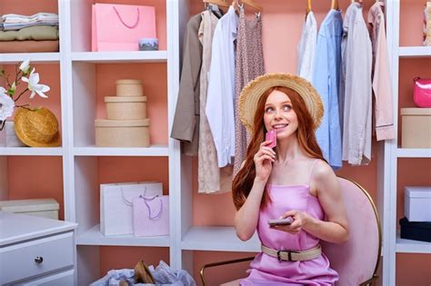Premium Photo Happy Redhead Woman Among Many Clothes In Her Closet