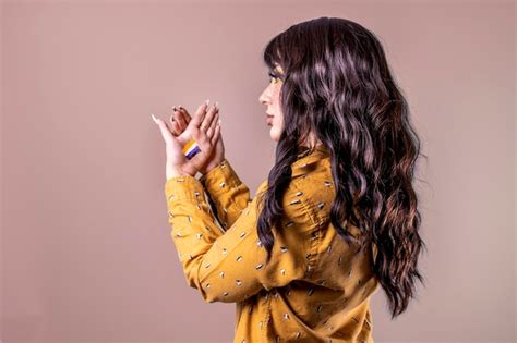 Premium Photo Young Nonbinary Woman Showing Nonbinary Gender Flag In Hand