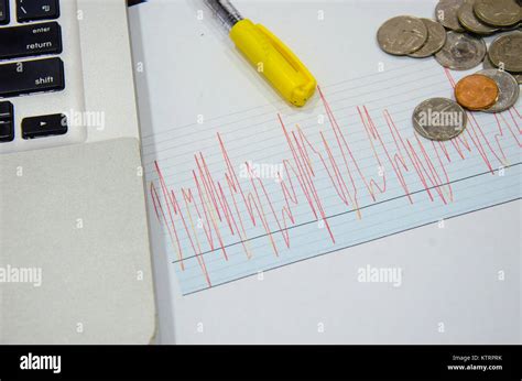 Line Graph And Coins And Laptop Computers Stock Photo Alamy