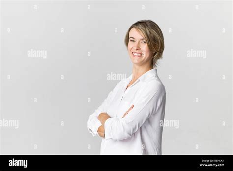 Amazing And Cheerful Smiling Blonde In White Shirt Studio Shot