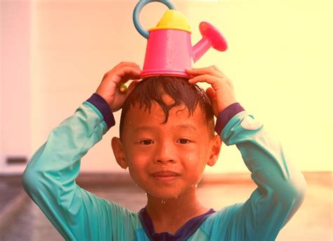 Premium Photo Portrait Of Cute Wet Babe Holding Toy On Head