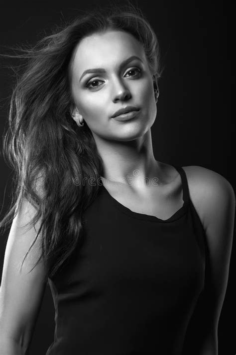 Glamor Brunette Model With Curly Hair Wearing Blouse And Necklace Posing Behind The Glass Door
