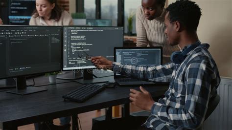 App Developer Removing Glasses While Explaining Algorithm To Colleague