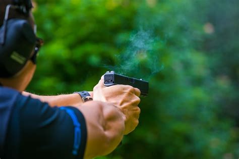 Small Puff Of Smoke Coming From A Handgun After Being Fired Premium Photo