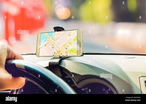 Female Driver Sitting In The Car Use Mobile Smart Phone With Map Gps Navigation Application