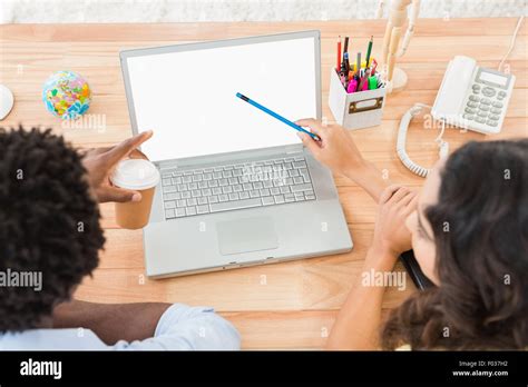 Colleagues Brainstorming And Pointing Laptop Screen Stock Photo Alamy