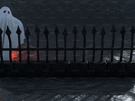 A White Ghost Sitting On Top Of A Fence Photo Cemetery Image On Unsplash