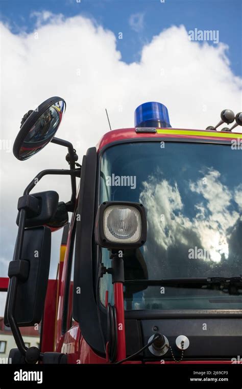 Fire Engine With Reflective Sky And Clouds On The Windshield Rescue And Safety Concept Close