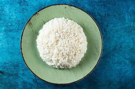 Premium Photo Plain Boiled Rice In A Plate Top View On Marble Background