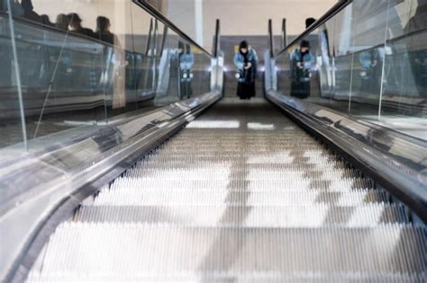 Premium Photo Female Using Escalator To Go Up To Next Floor